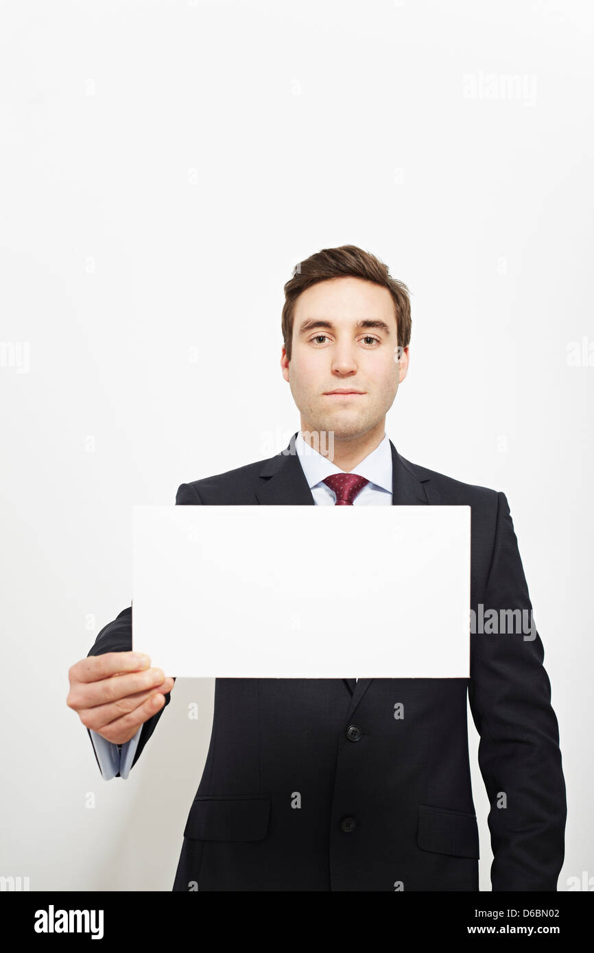 Businessman holding blank card Stock Photo - Alamy