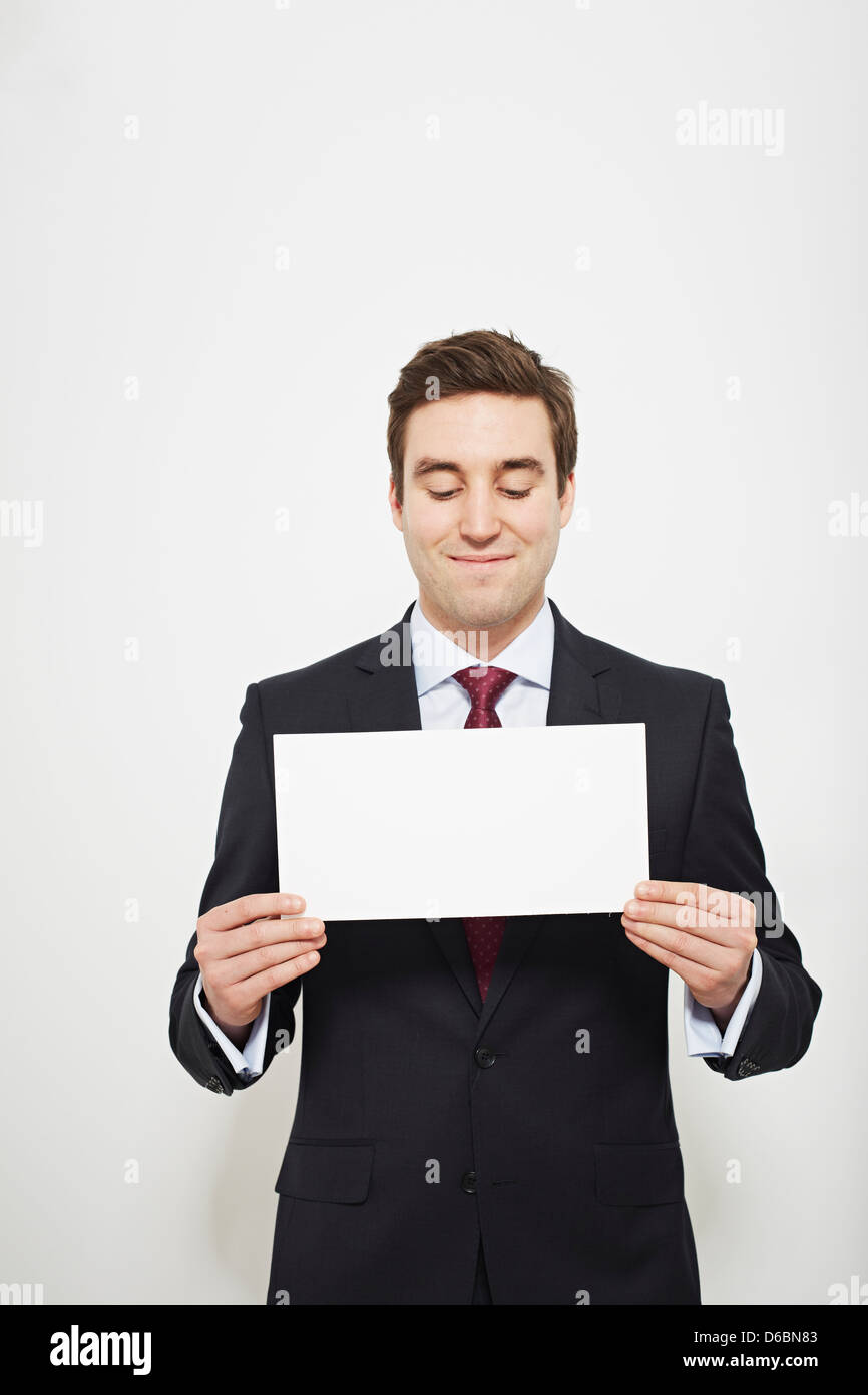 Businessman holding blank card Stock Photo - Alamy