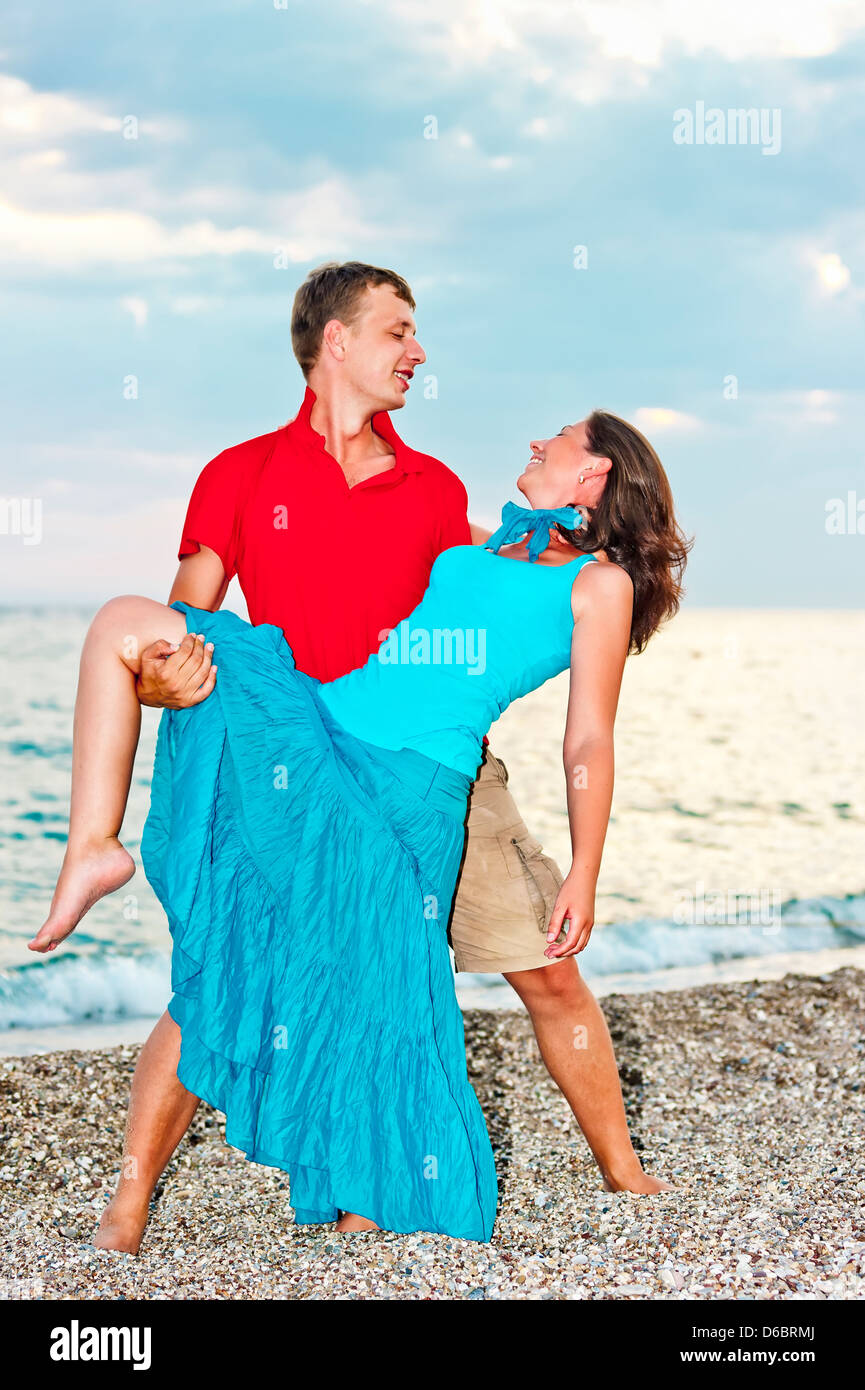 Young couple dancing on the sandy sea beach Stock Photo - Alamy