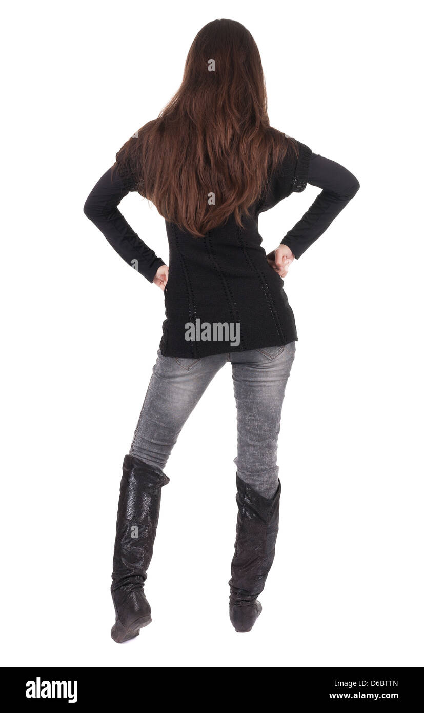 Back view of standing young beautiful woman. Girl in jeans and sweater ...