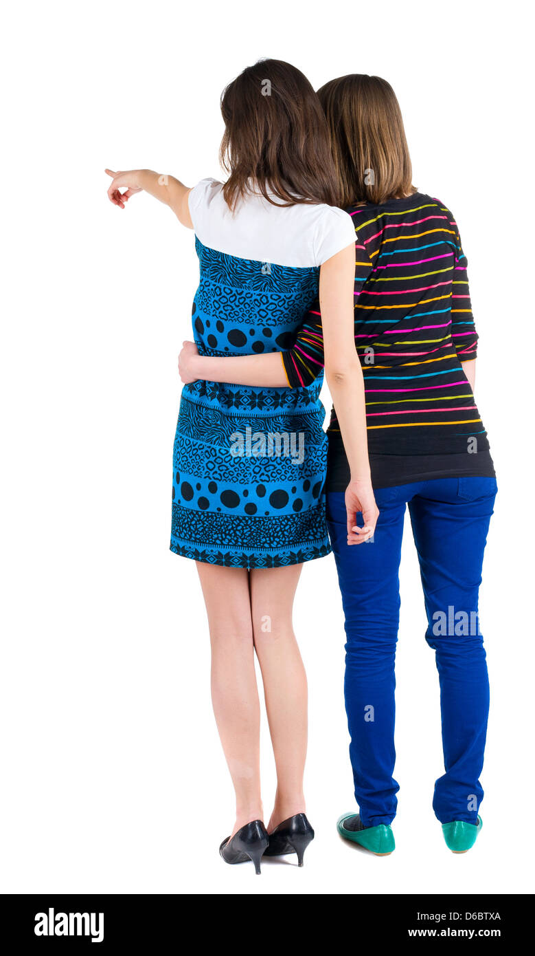 Back view of two pointing young brunette woman. Beautiful girl friends ...