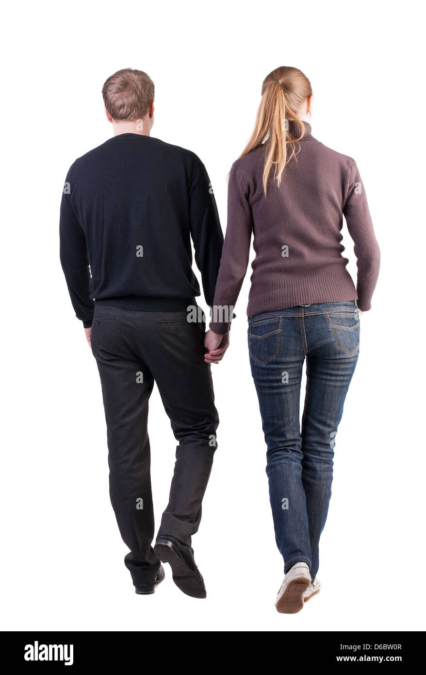 Back view of walking young couple. Going beautiful friendly girl and ...