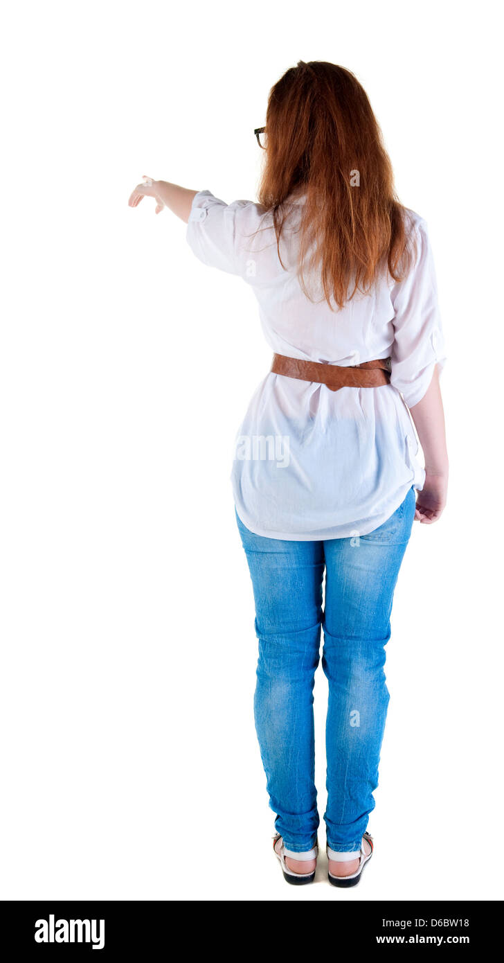 Back view of pointing beautiful red-haired woman. Young girl in jeans ...