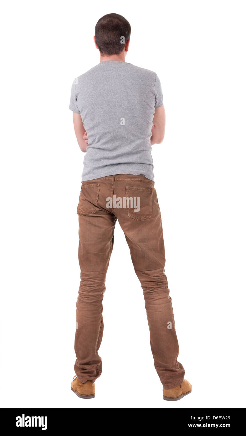 Back view of looking up handsome man in jeans. Standing young guy. Rear ...