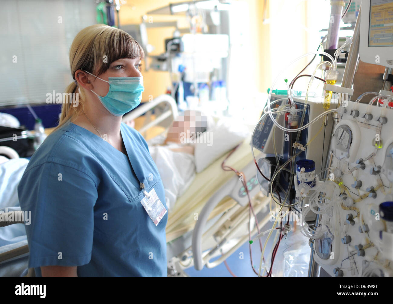 (dpa FILE) - An archive picture shows a nurse wearing a mask as she ...