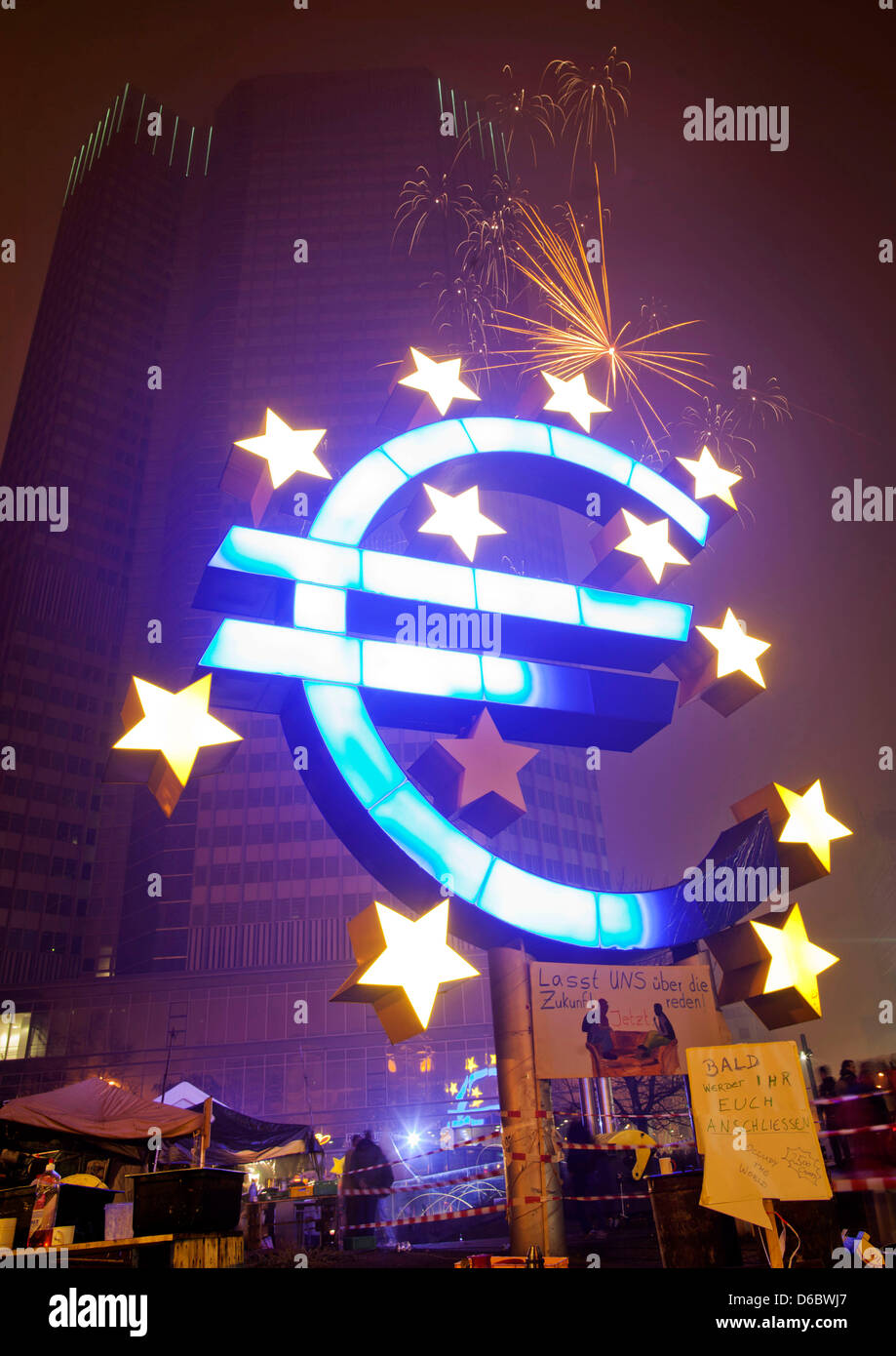 A single firework explodes aboth the Euro sculpture in front of the ...