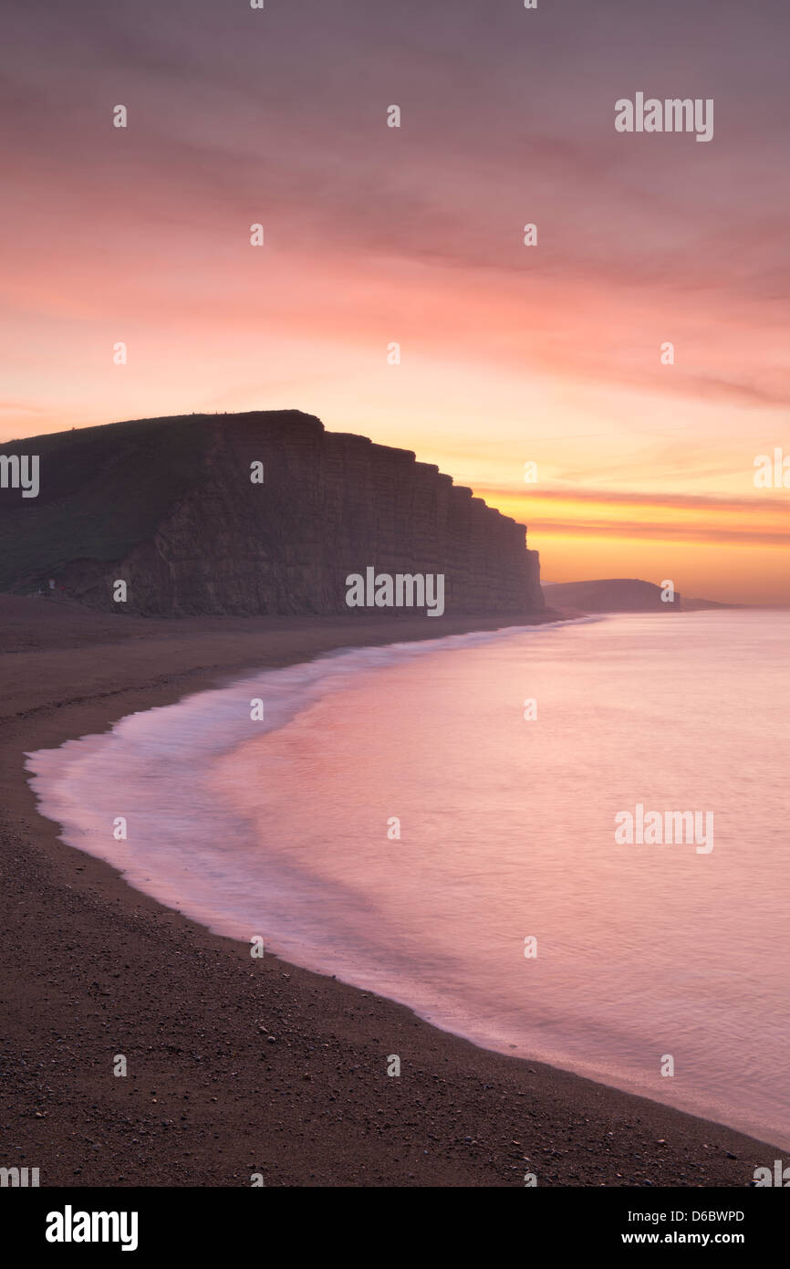A stunning red sunrise in the sky above East Cliff at West Bay, Dorset ...