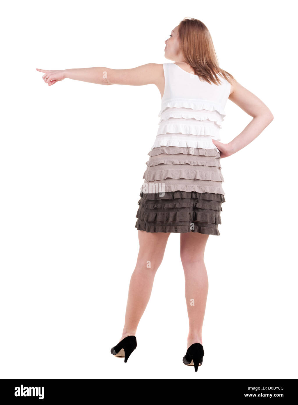 Back view of young blonde woman pointing. Beautiful girl in dress ...