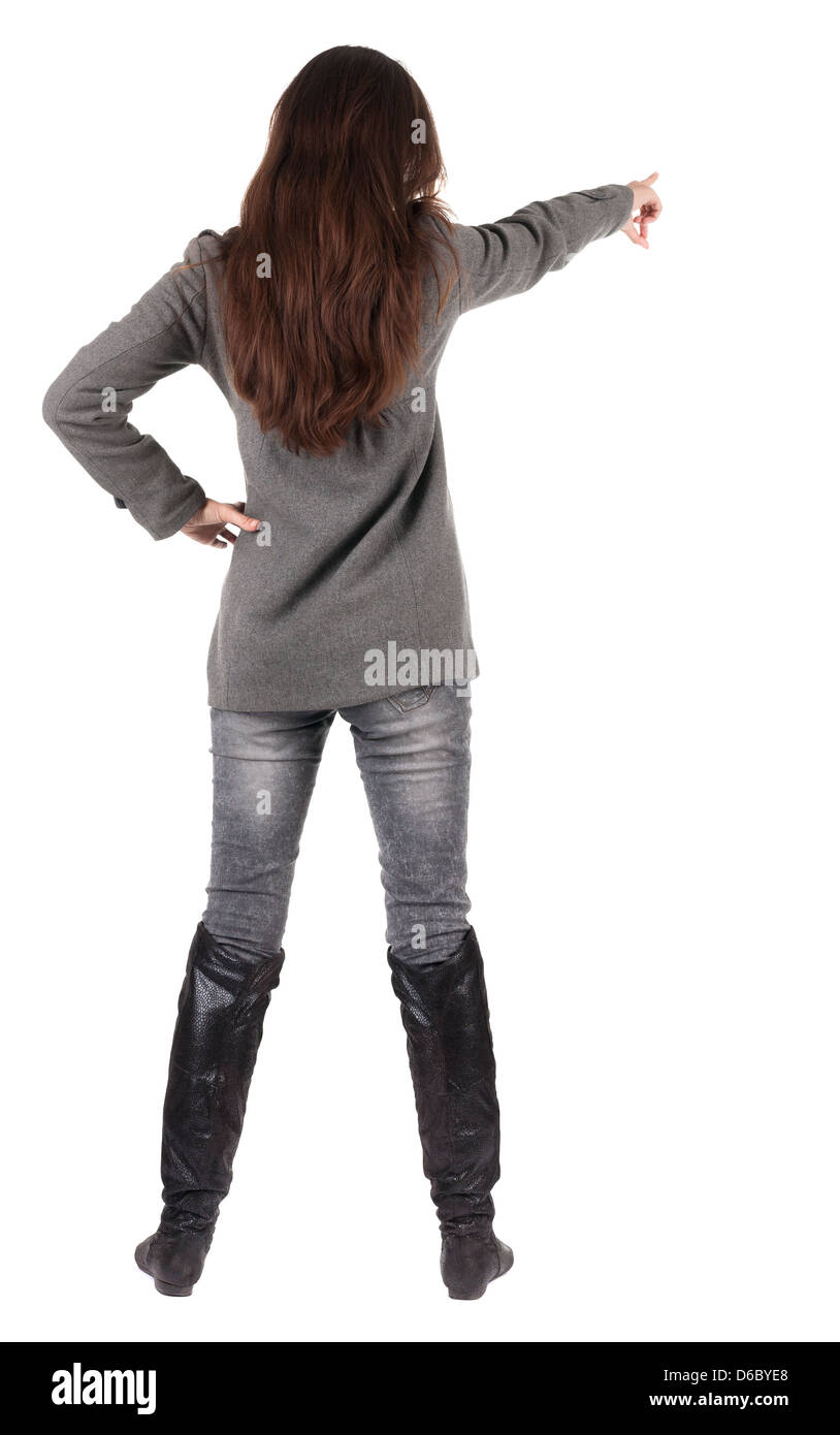 Back view of pointing woman. beautiful brunette girl in coat. Rear view ...