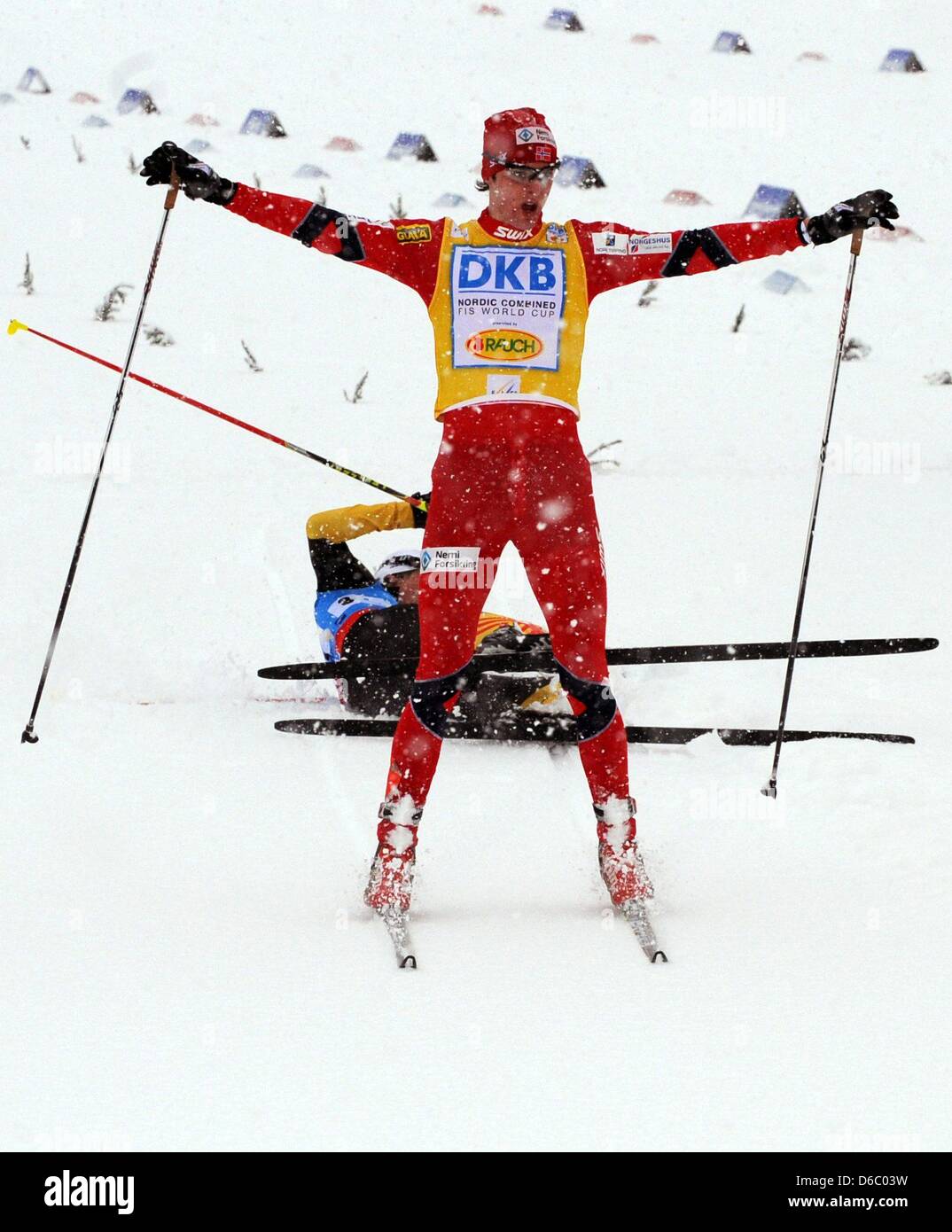 Norwegian athlete Joergen Graabak (R) celebrates the victory of the ...
