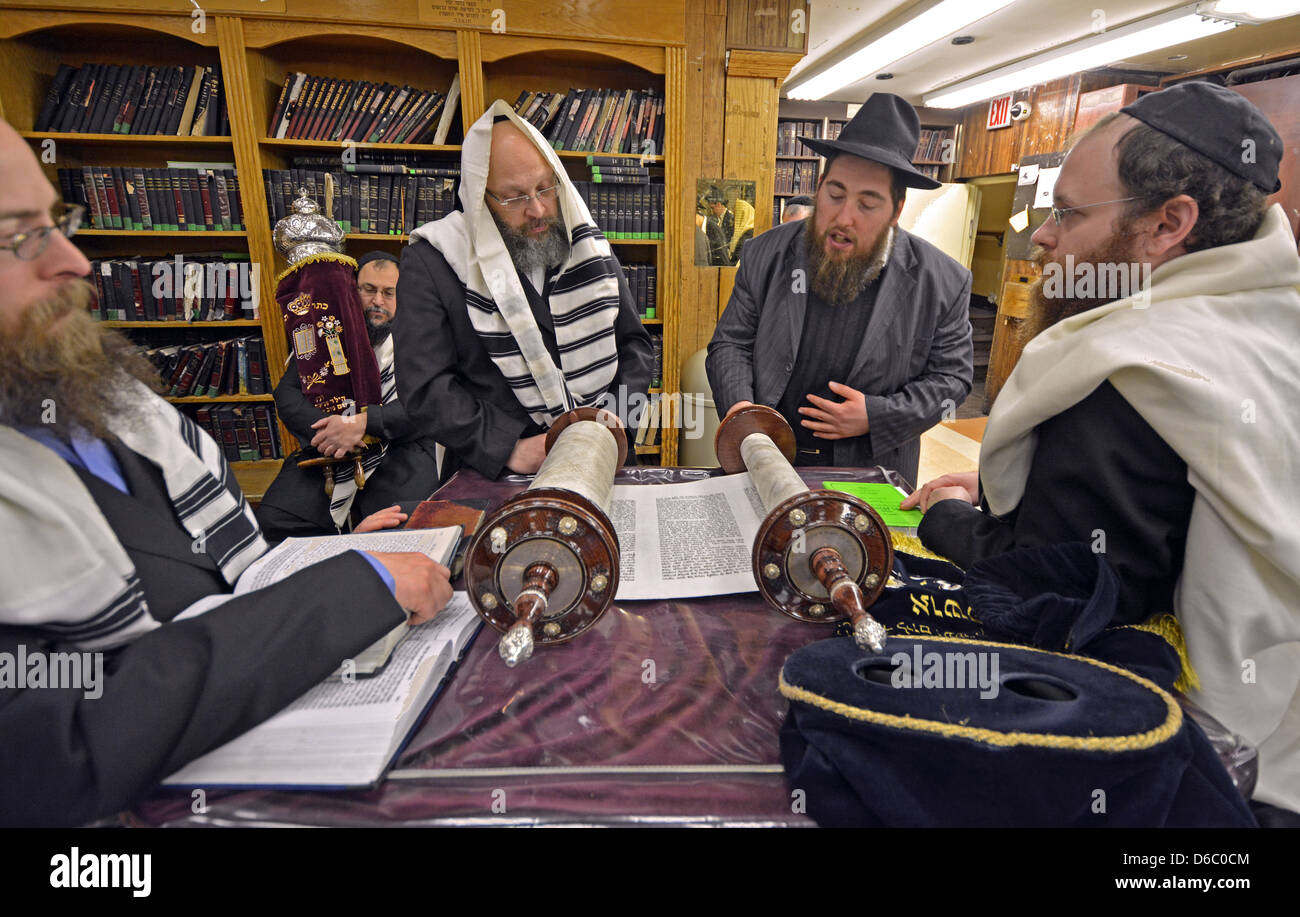 Reading from a Torah scroll at morning services during Passover at ...