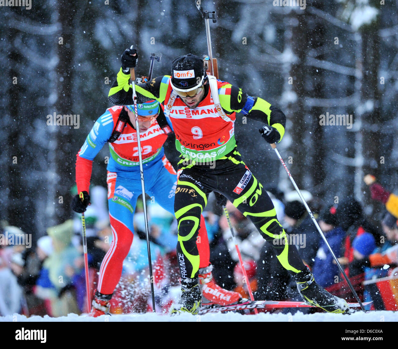 French biathlete Simon Fourcade is followed by Russian biathlete Anton ...