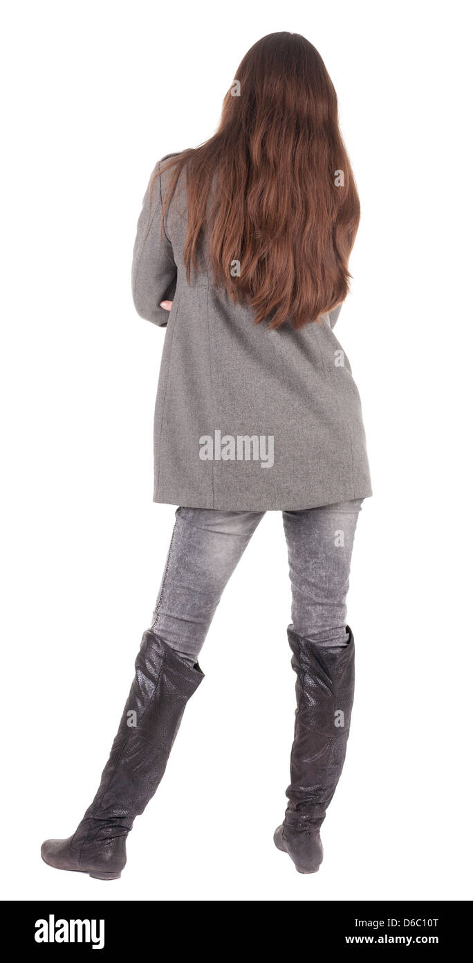 back view of standing young beautiful woman. brunette girl in jeans and ...