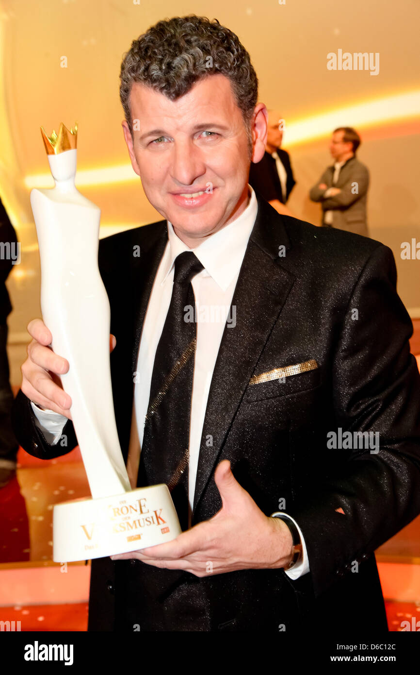 Folk music singer Semino Rossi reacts after receiving an award during ...