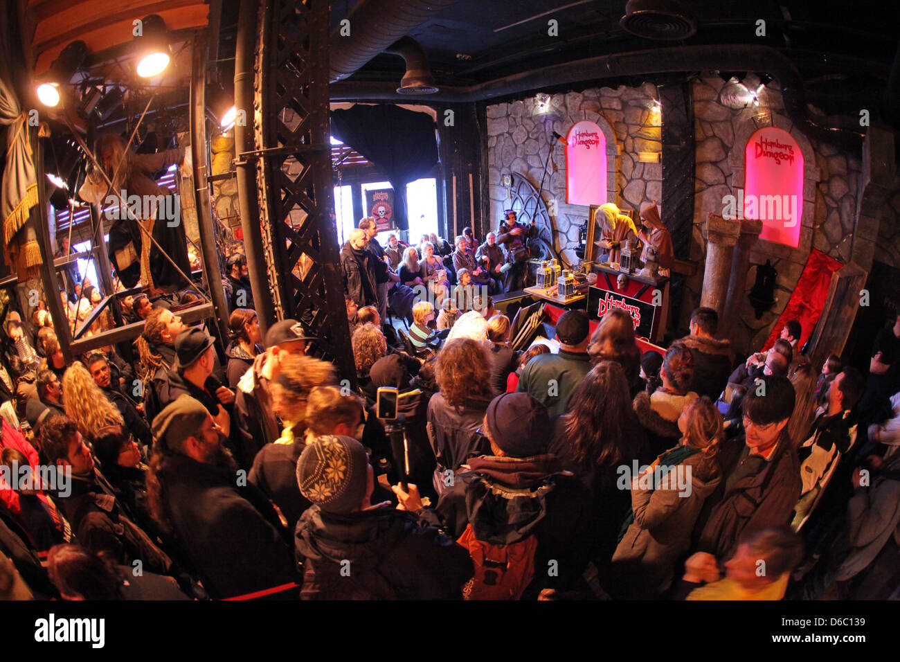 People attend the auction at the restaurant of the chamber of horrors ...