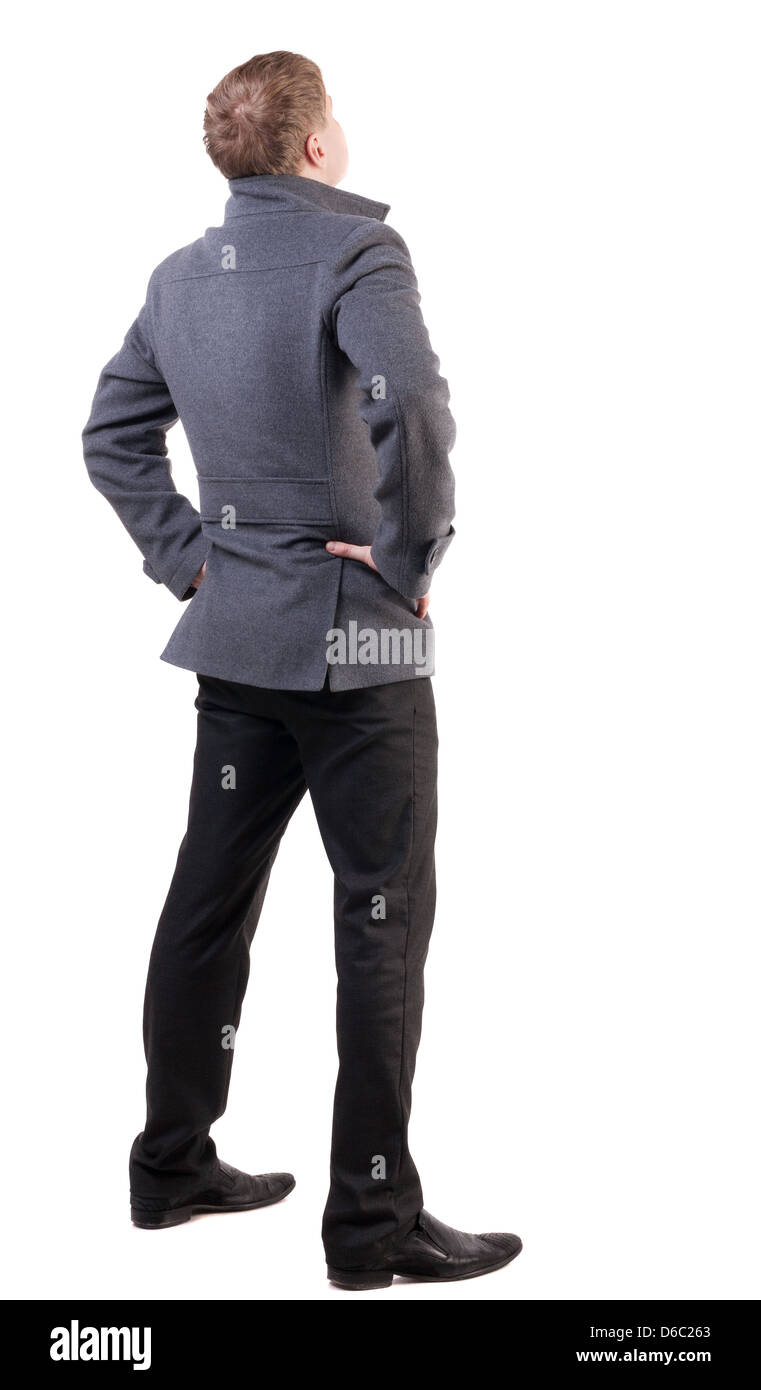 Back view of business man looks ahead. Young guy in coat watching. Rear ...