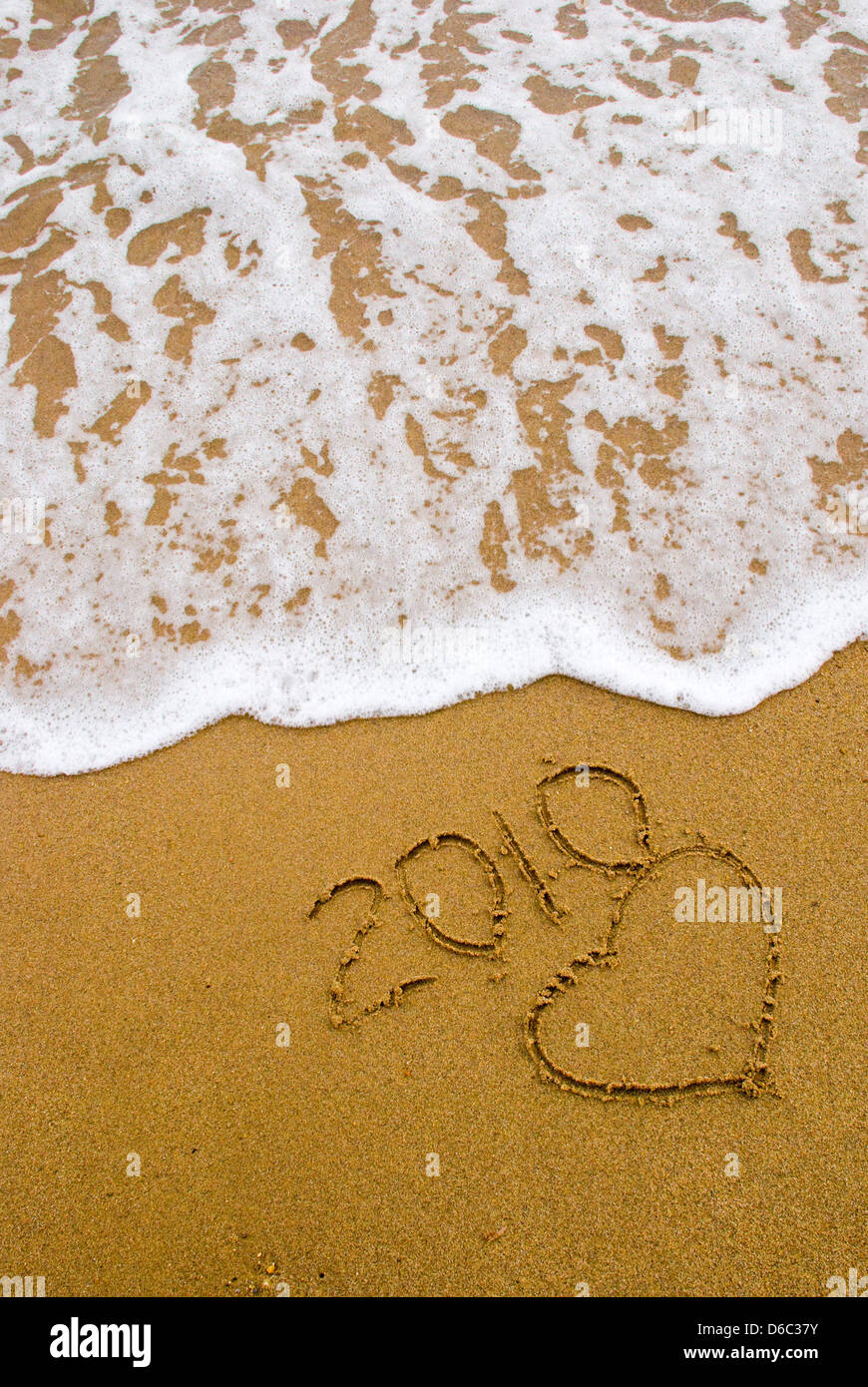 Year 2010 written on the sand Stock Photo - Alamy
