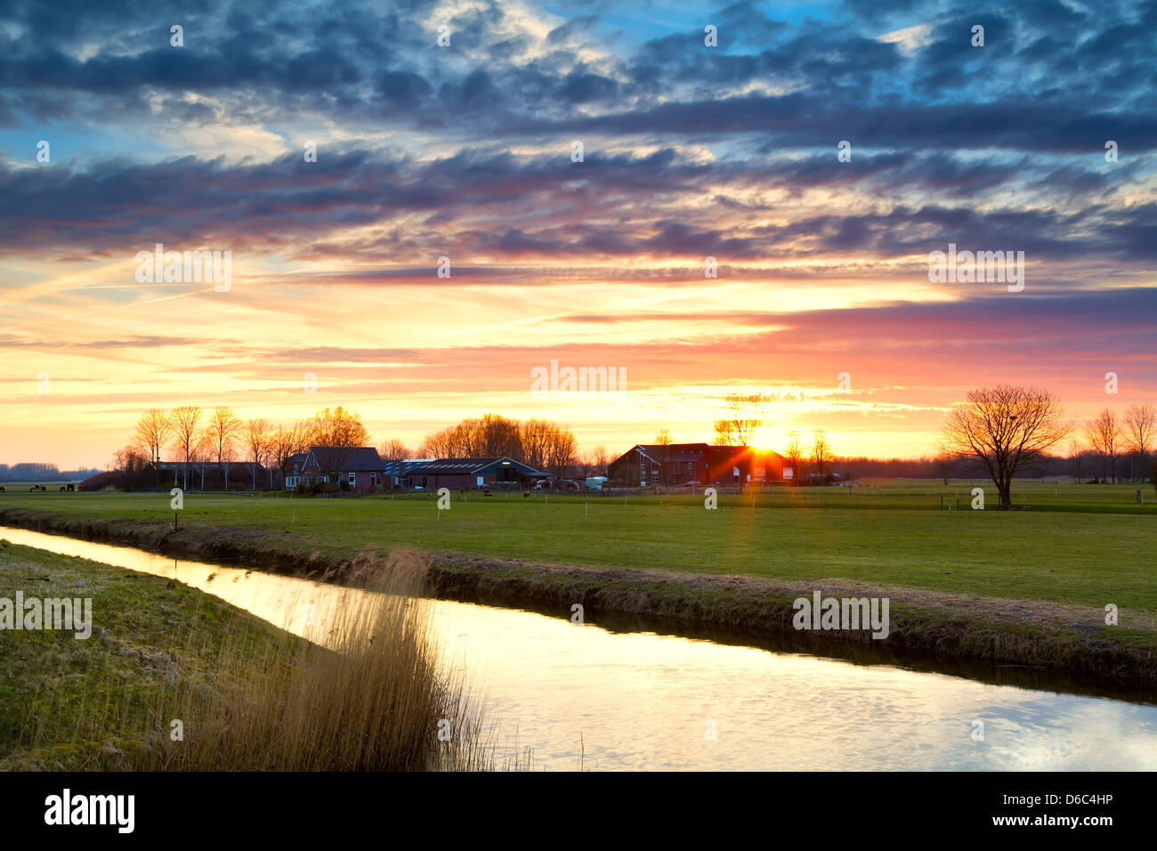 beautiful sunset over river in Dutch farmland Stock Photo - Alamy