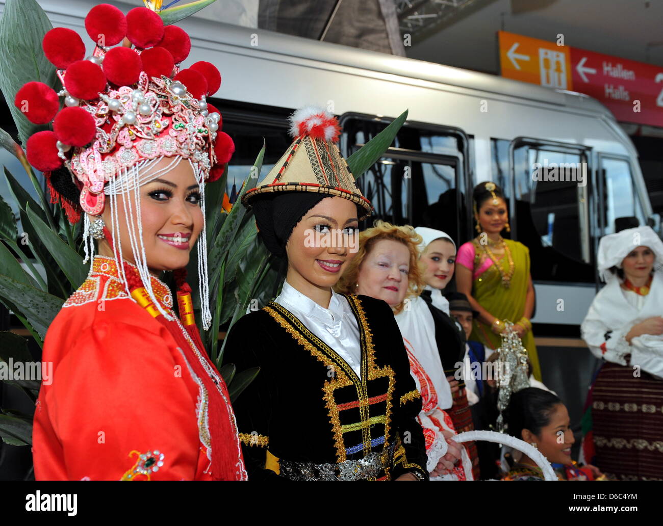Women dressed in Malaysian traditional costumes perform at the run-up ...
