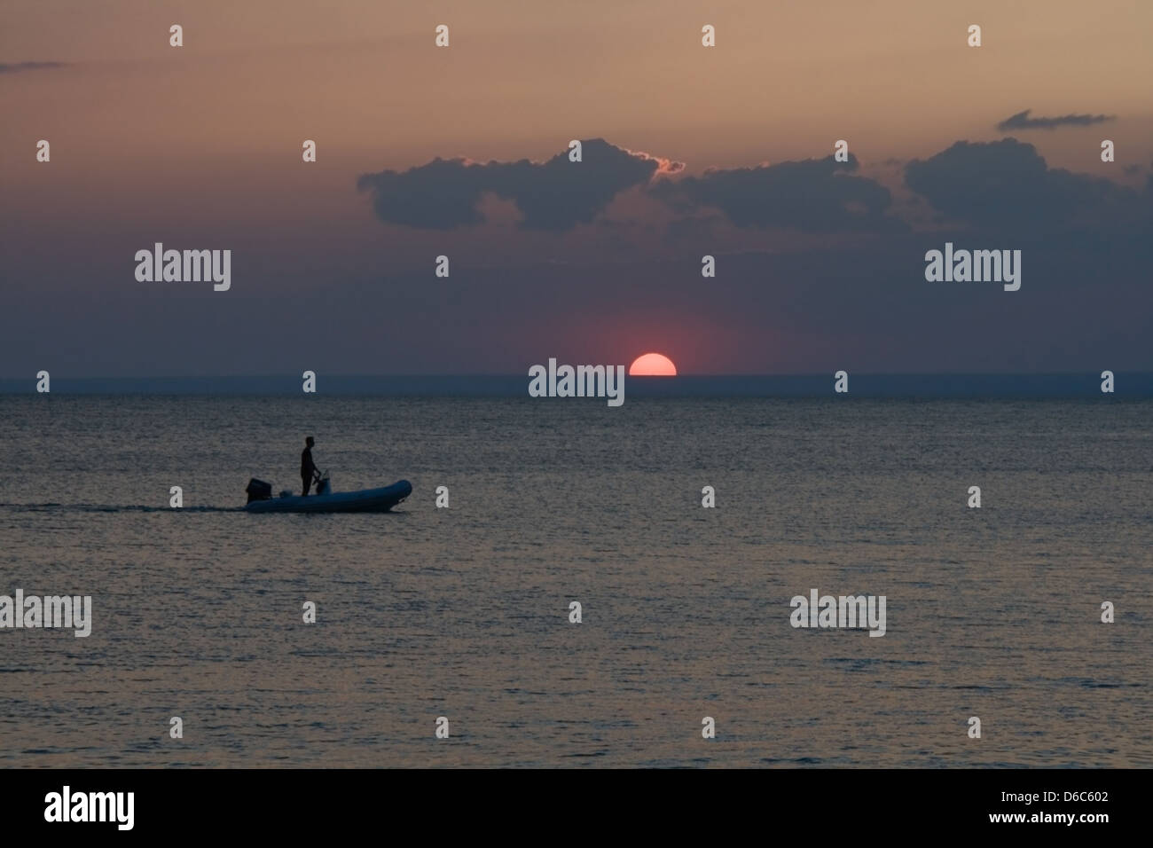 A man relaxing on a boat at Sunset Stock Photo - Alamy