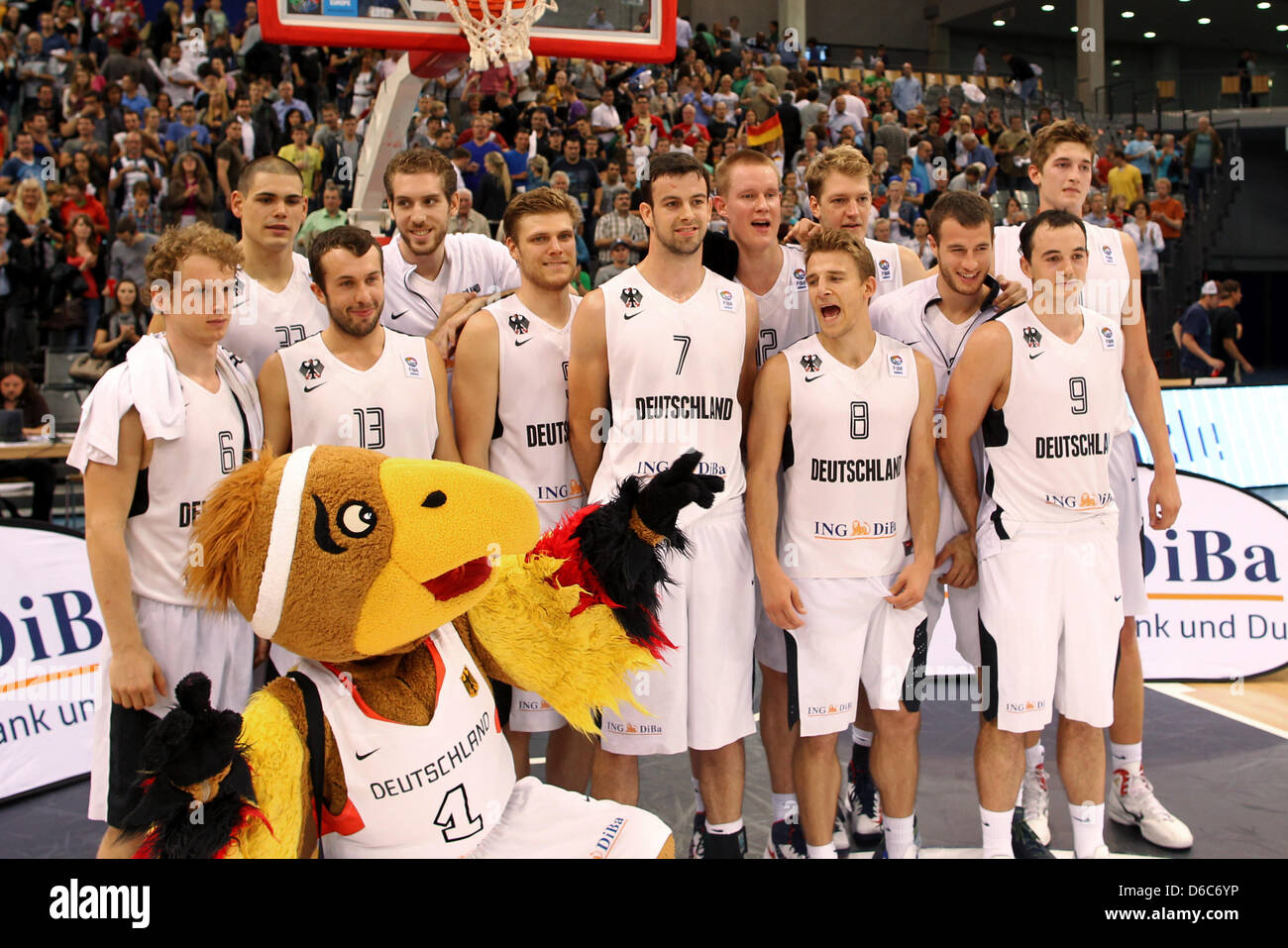 The German poses for photographs after the 79-69 victory in the ...