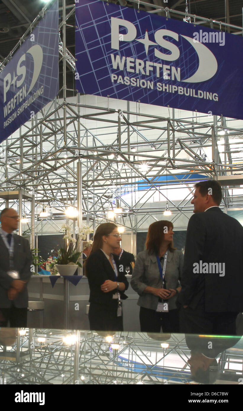 Visitors walk past the exhibition stand of P+S Shipyards at the ...