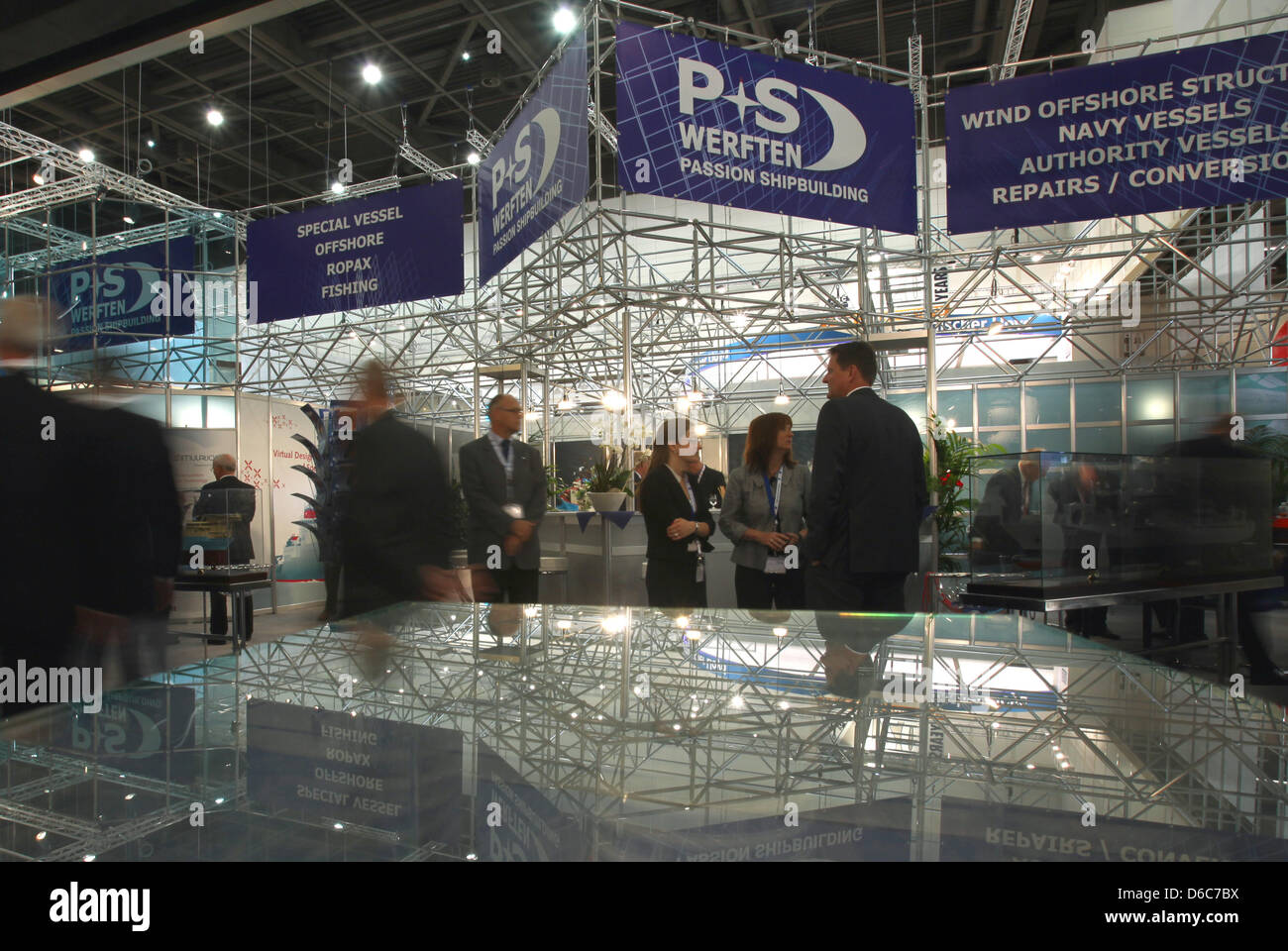 Visitors walk past the exhibition stand of P+S Shipyards at the ...