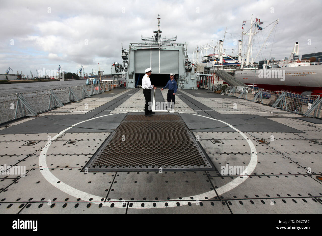 Two crew members talk on the helideck of Type 23 'Duke' Class frigate ...