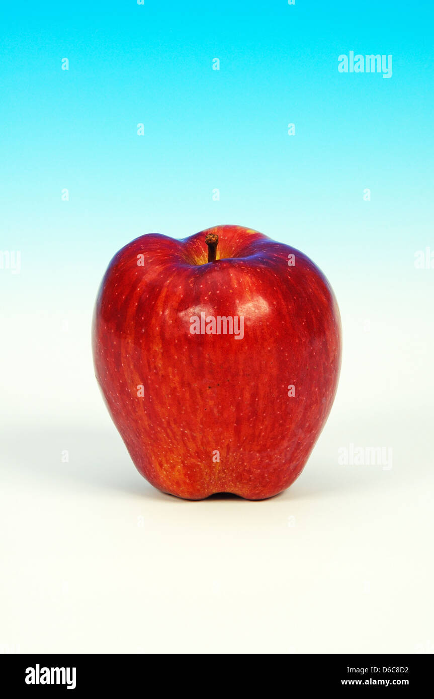 Red Apple against a blue and white background Stock Photo - Alamy