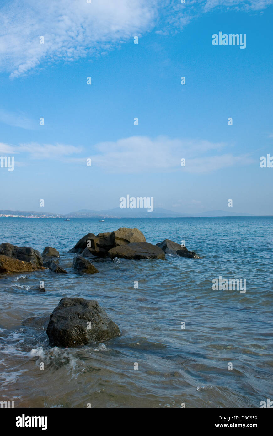 Coast of sea with stones in water Stock Photo - Alamy