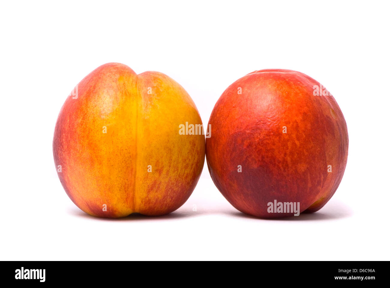 Two juicy nectarines on a white background Stock Photo - Alamy