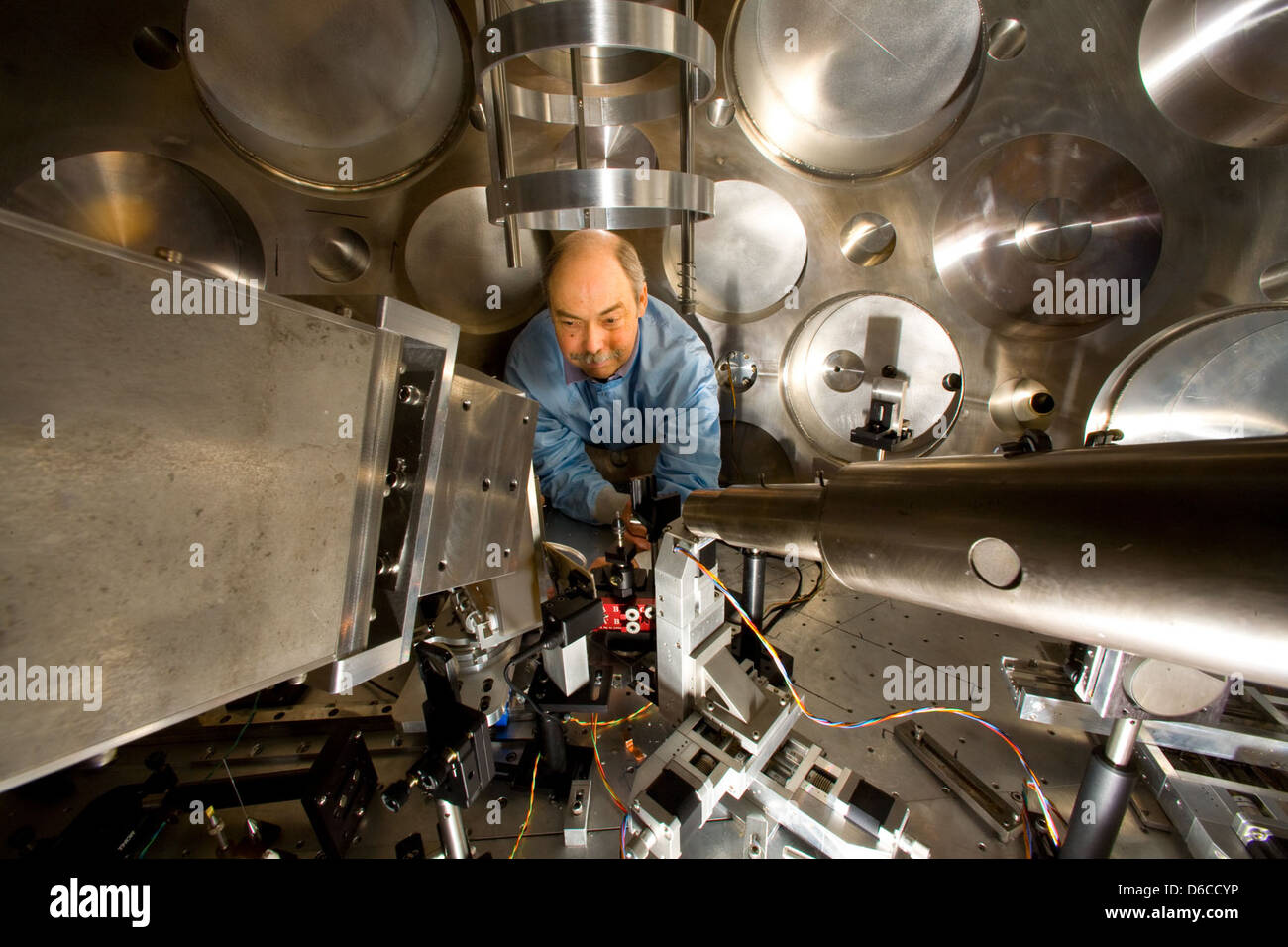 A scientist adjusts diagnostics for a plasma experiment at the Trident ...