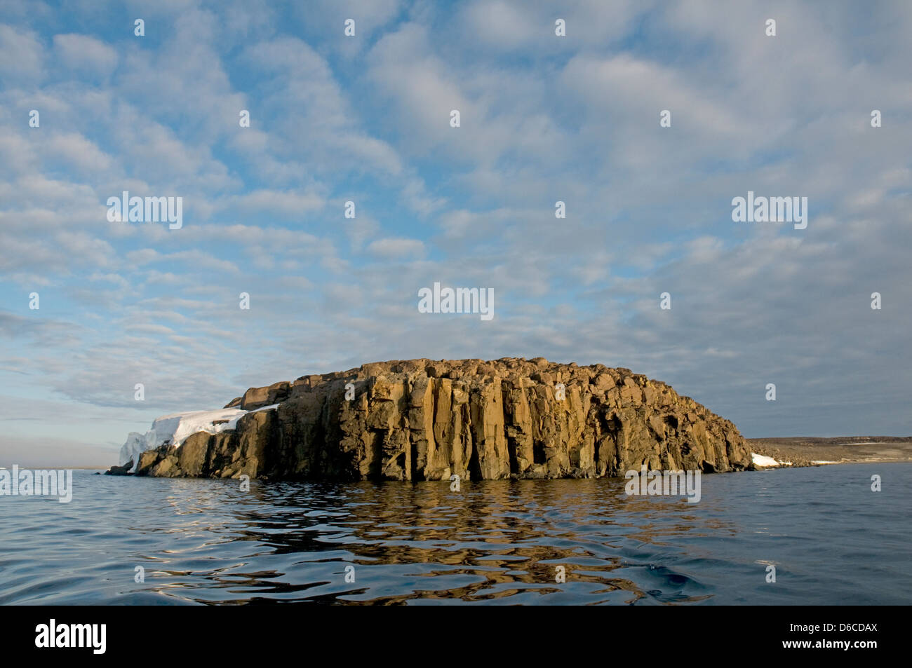 Norway Svalbard Archipelago Spitsbergen Clouds flow over a rock island ...