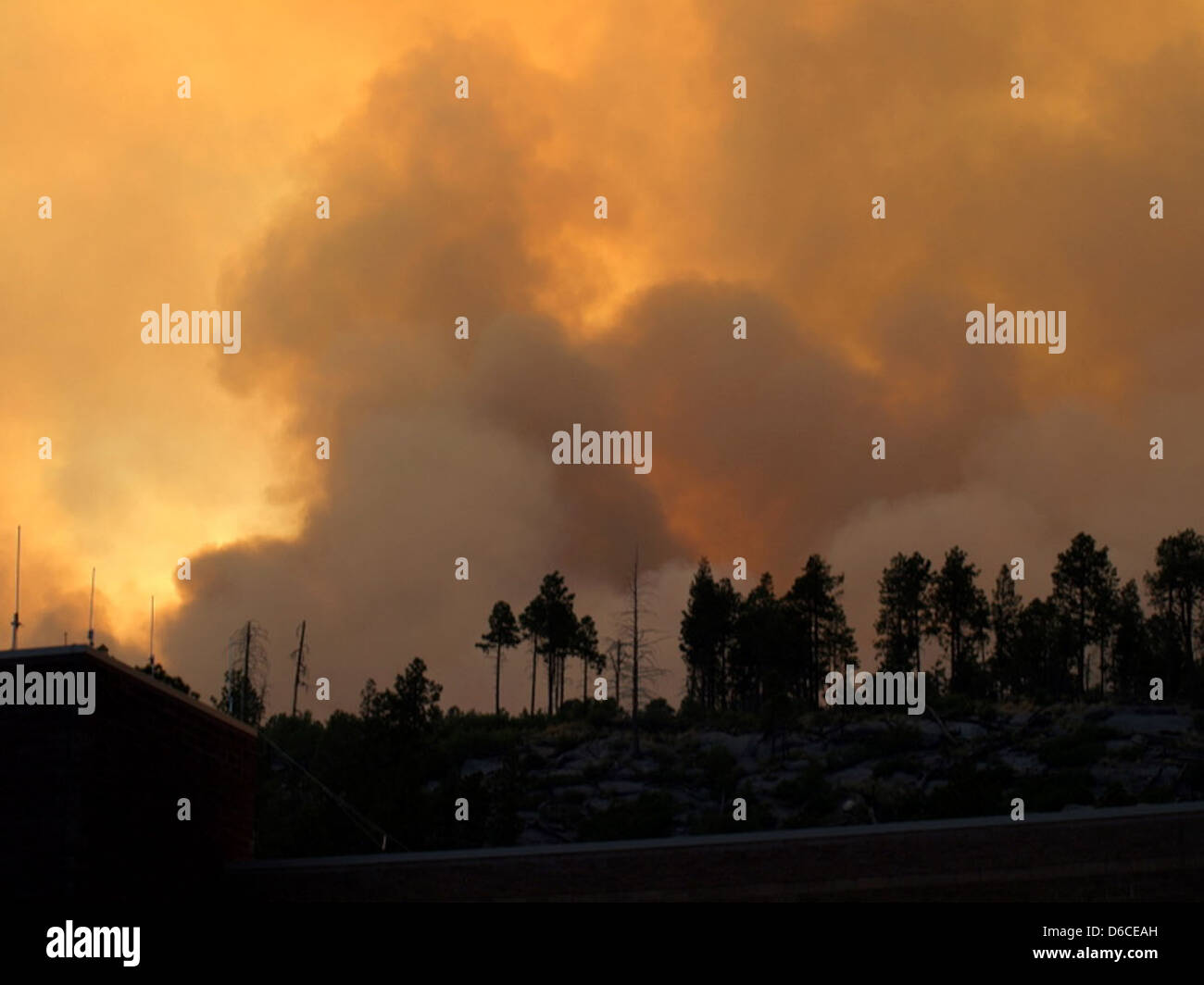 A photograph depicting smoke over the ridge at Los Alamos National ...