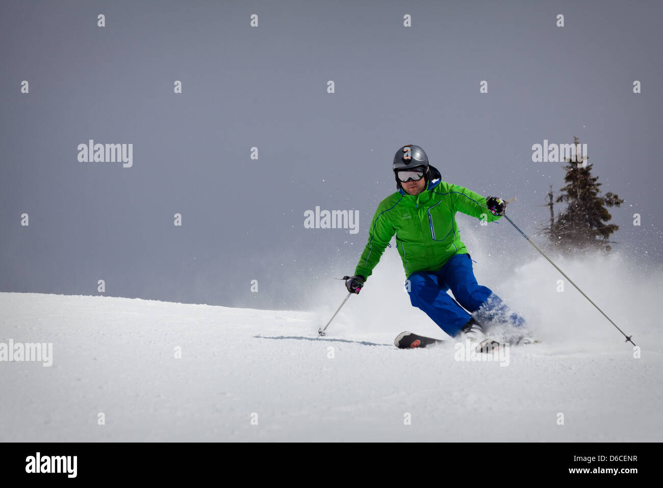 A skier throwing up powder as he turns Stock Photo - Alamy