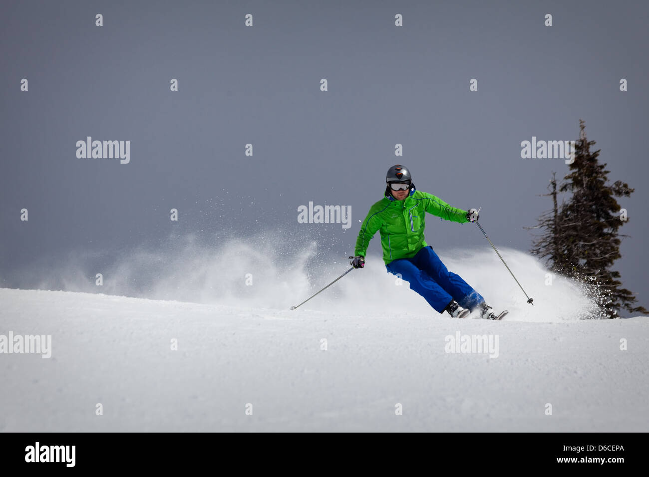 A skier throwing up powder as he turns Stock Photo - Alamy