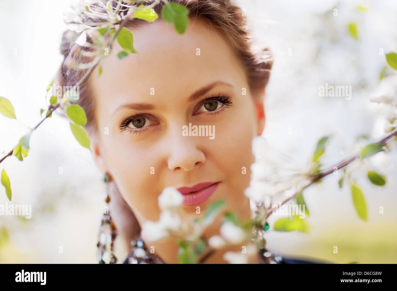 Beautiful woman in a spring garden Stock Photo - Alamy