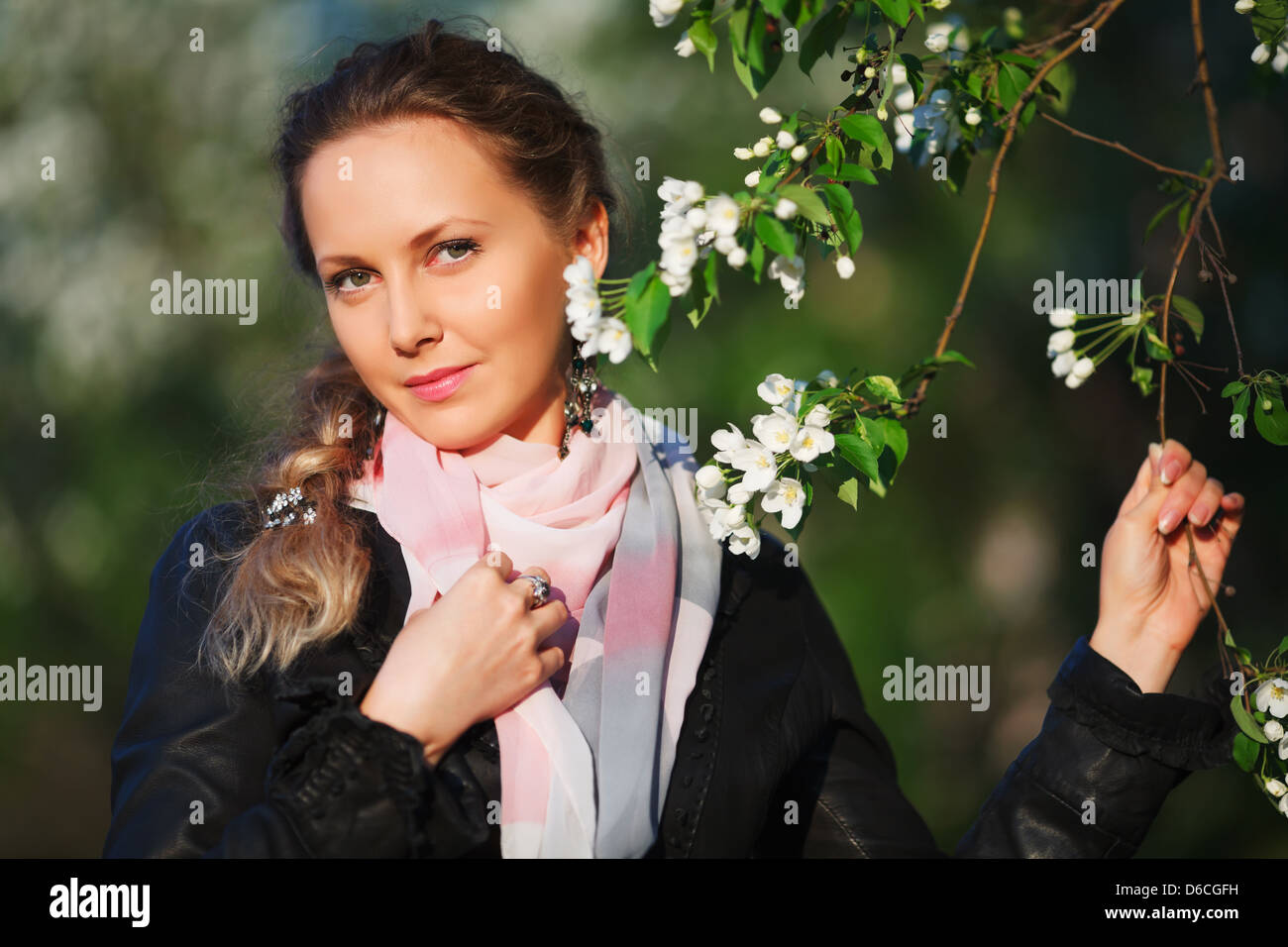 Beautiful woman in a spring garden Stock Photo - Alamy