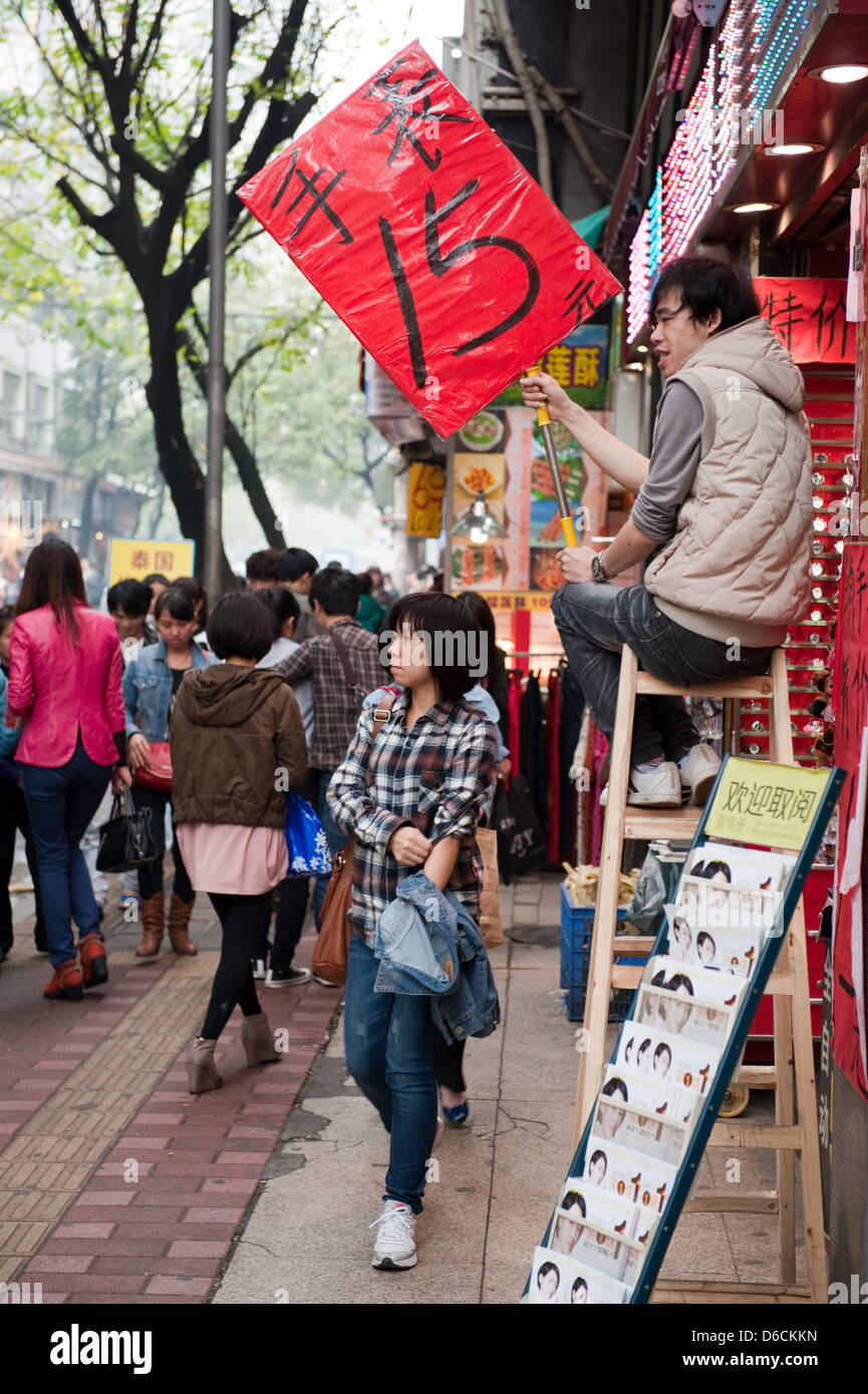 Guangzhou, China, a young salesman with price tag Stock Photo - Alamy