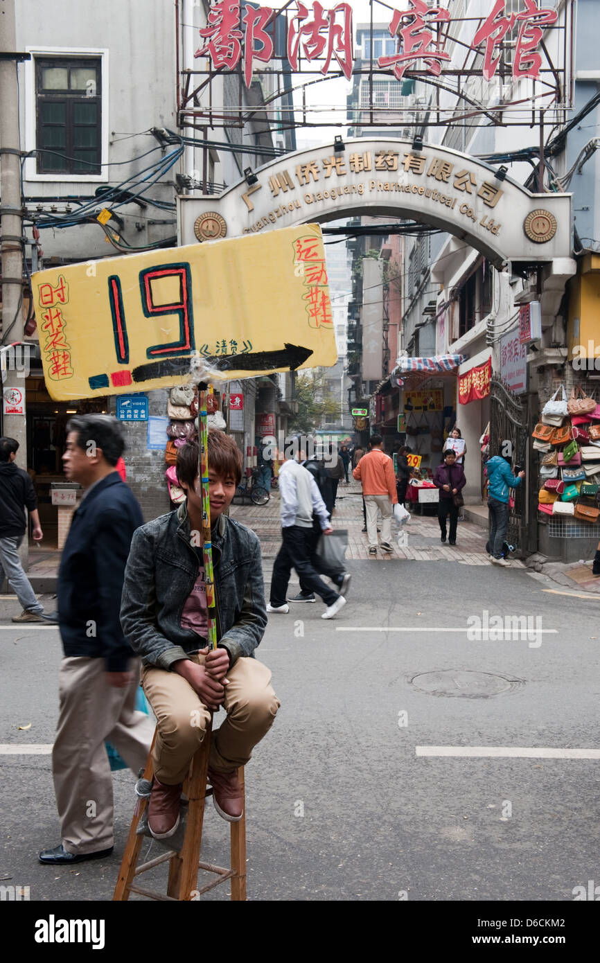 Guangzhou, China, a young salesman with price tag Stock Photo - Alamy
