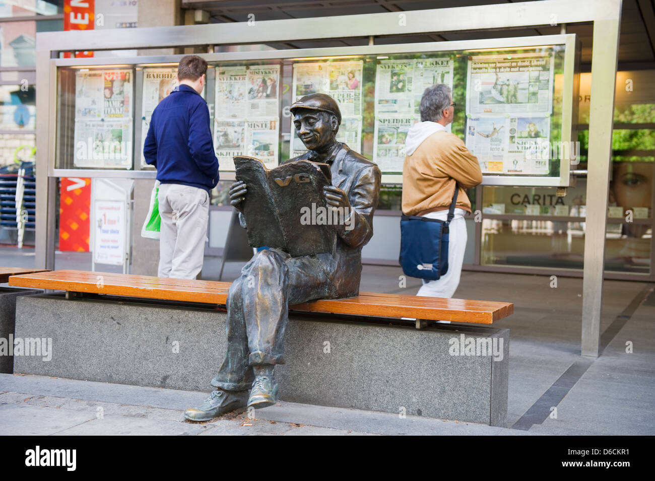 statue of a man reading a newspaper and free news stand, Oslo, Norway ...