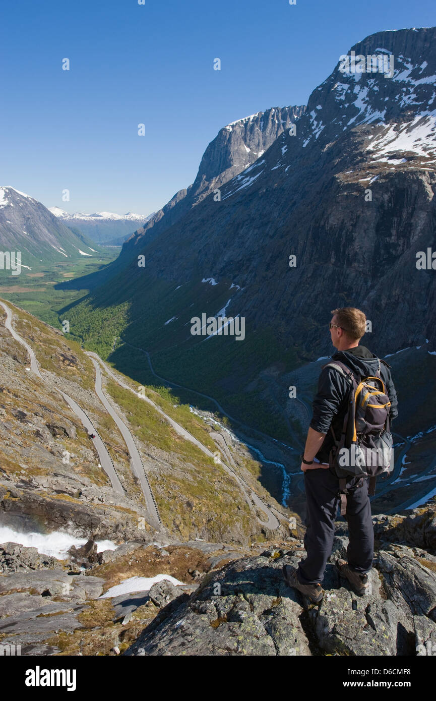 hiker above the winding road of Trollstigen, Trolls Path, Norway ...