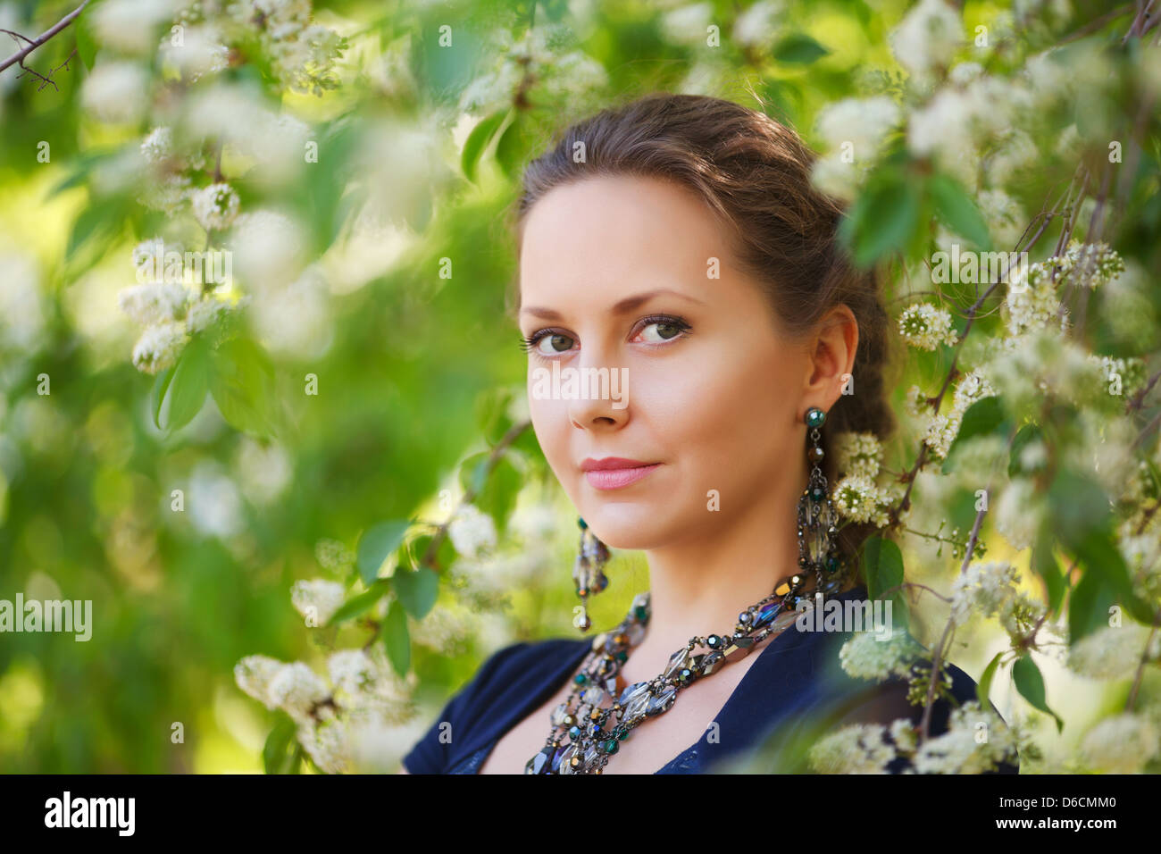 Beautiful woman in a spring garden Stock Photo - Alamy
