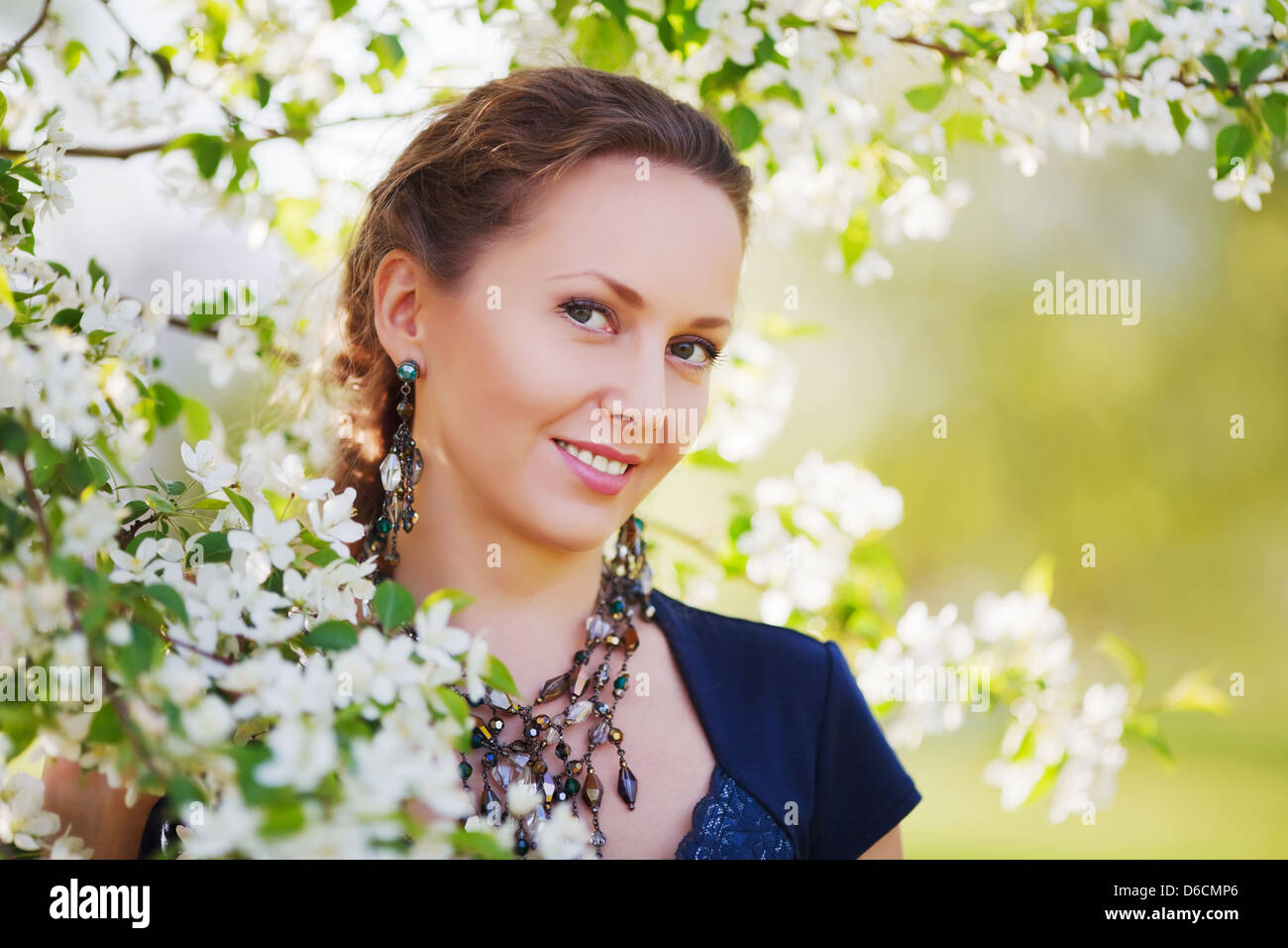 Beautiful woman in a spring garden Stock Photo - Alamy
