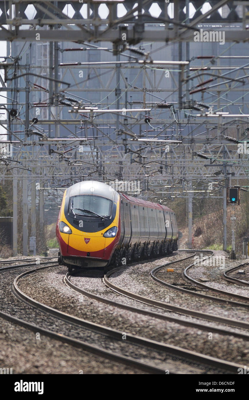 Virgin Pendolino express passenger train tilting around the bends at ...