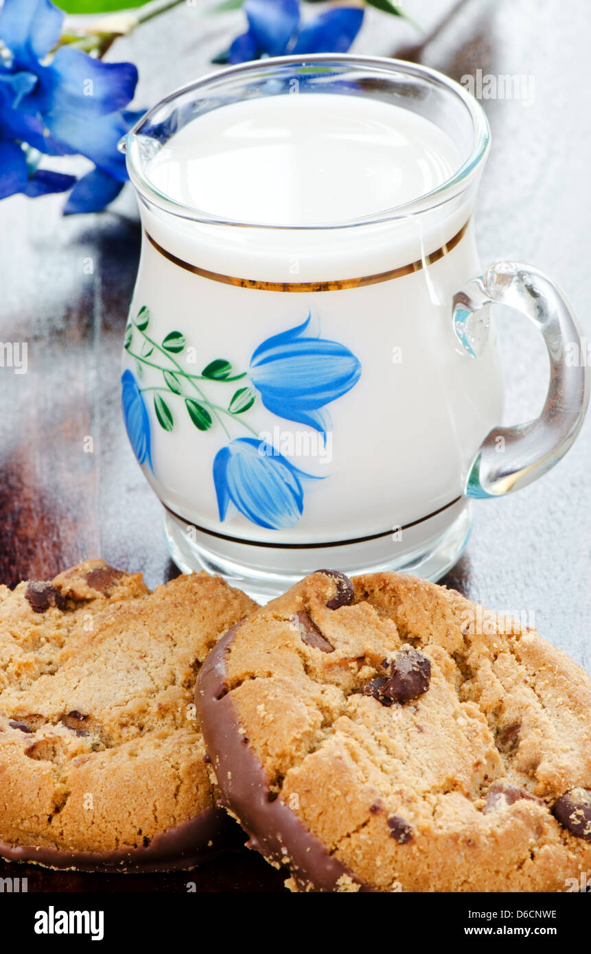 Two chocolate cookies and milk Stock Photo - Alamy