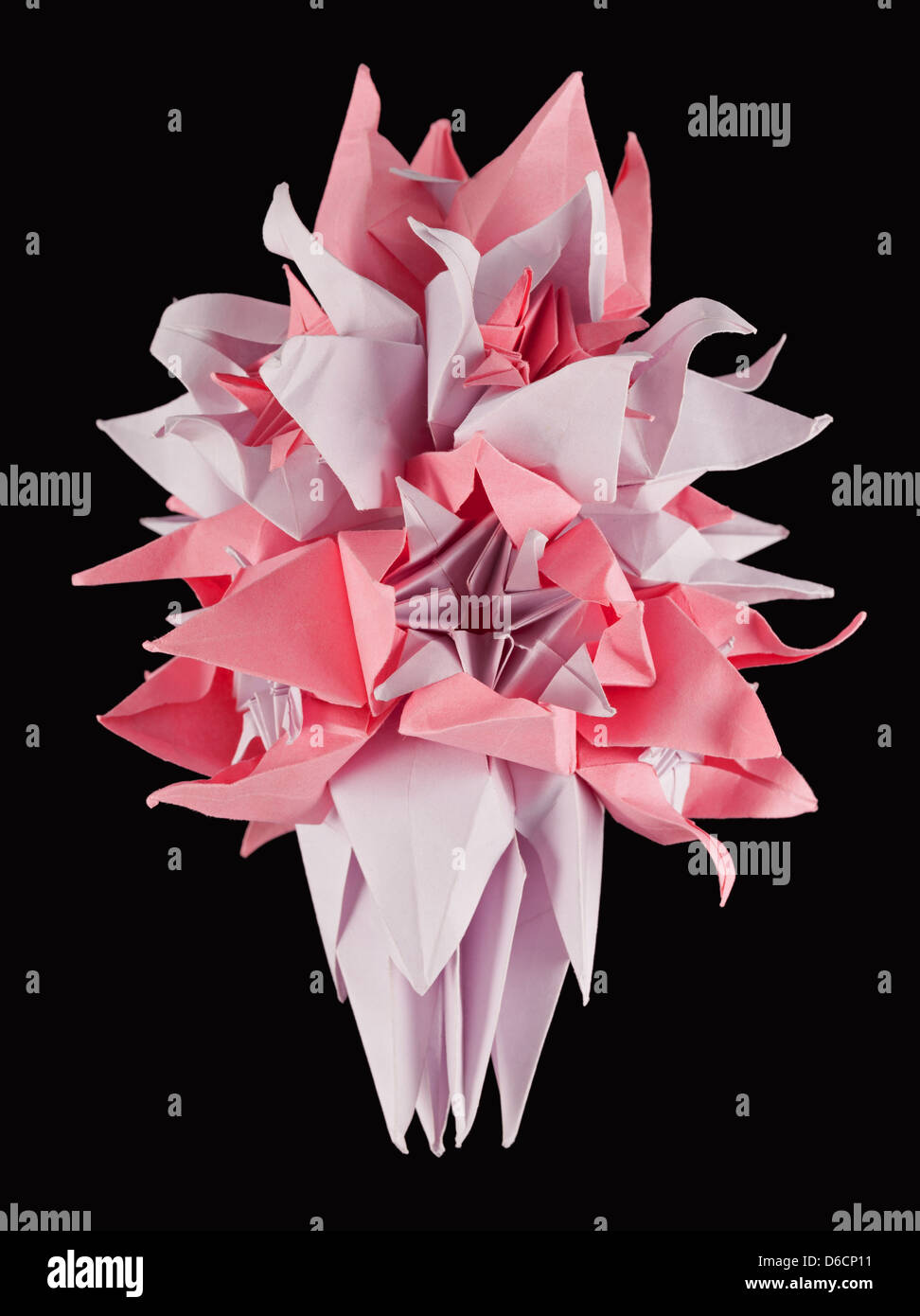 Pink white paper origami kusudama isolated on black Stock Photo - Alamy