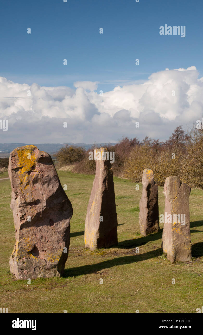 standing stones on grassy river bank, sunny day, white clouds, blue sky ...
