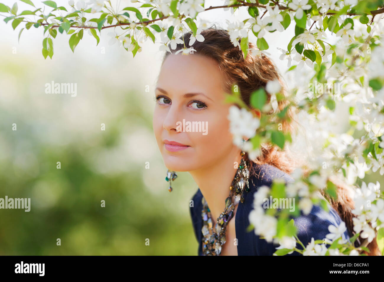 Beautiful woman in a spring garden Stock Photo - Alamy