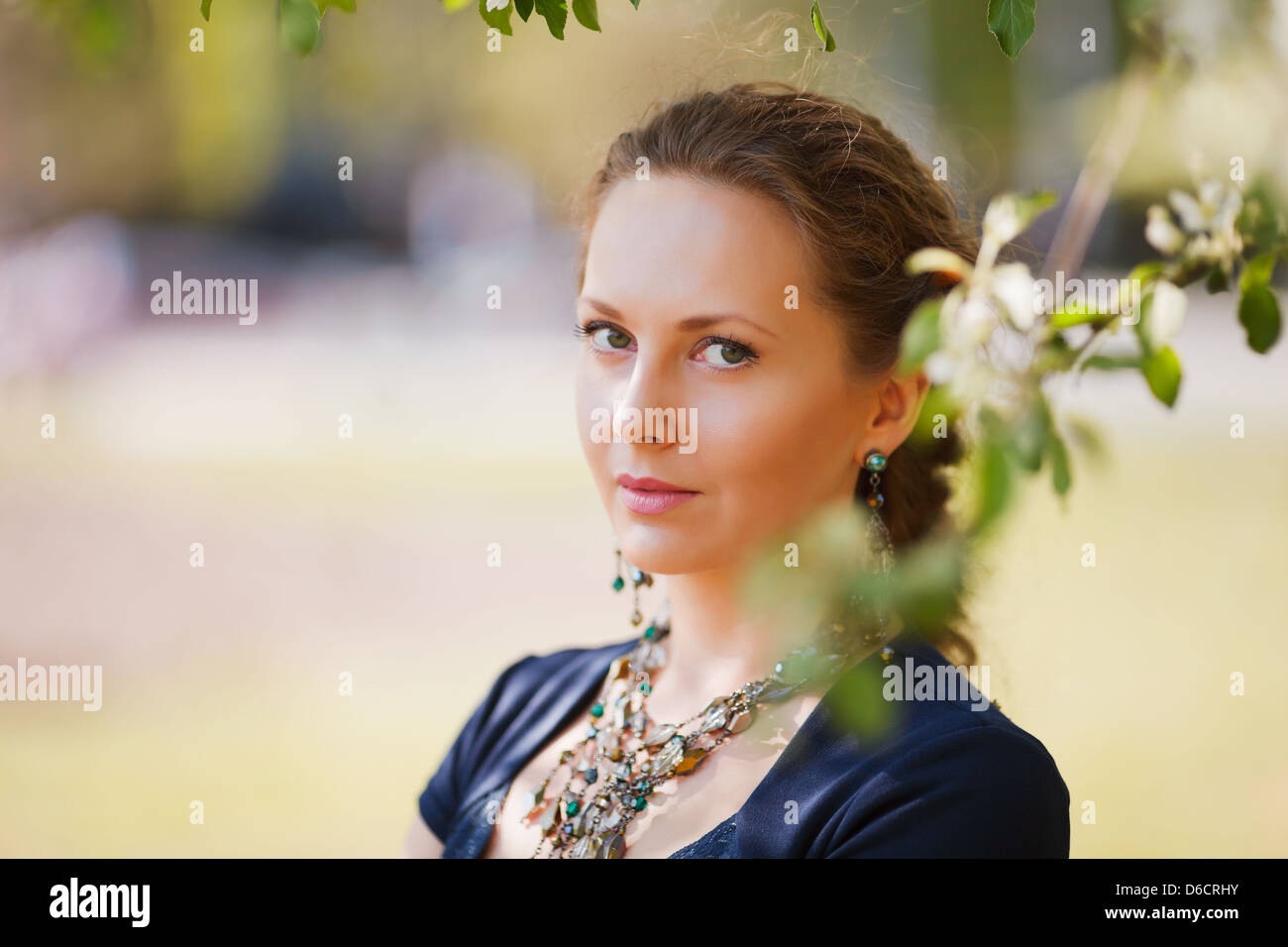 Beautiful woman in a spring garden Stock Photo - Alamy